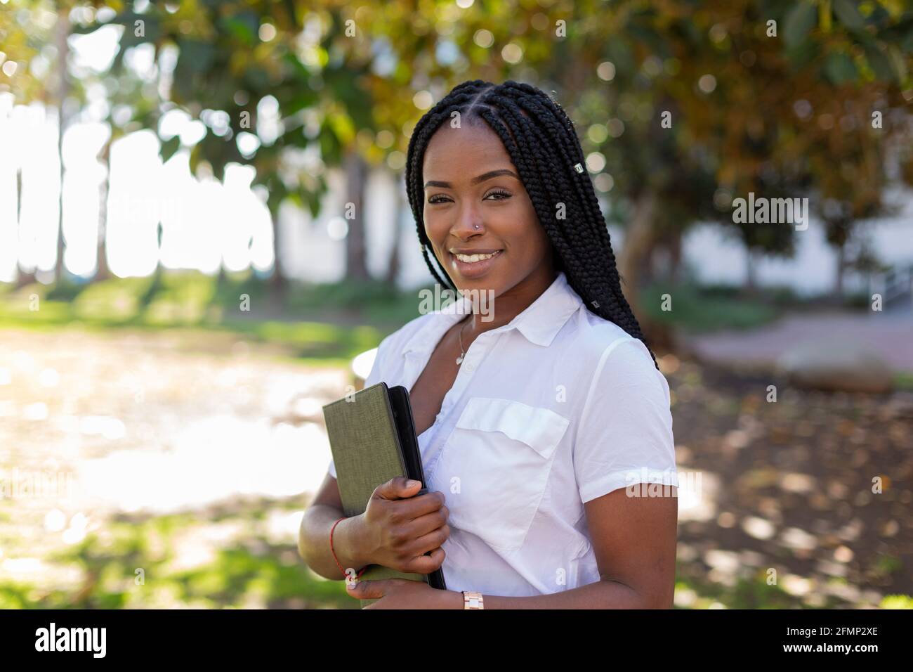 Beautiful African American student with nature background. University ...