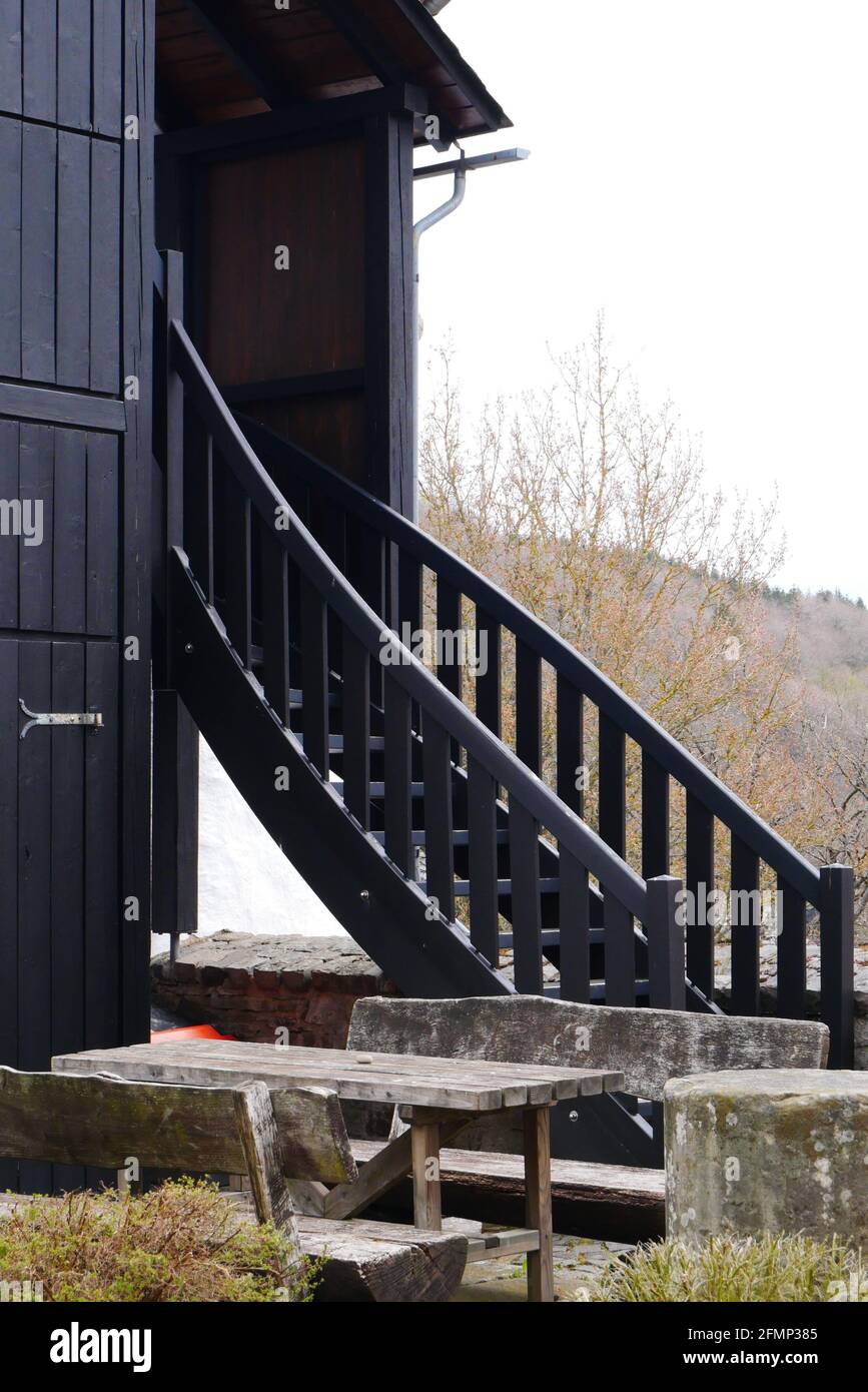 old black wooden stairs into a wooden barn in a mountainous landscape ...