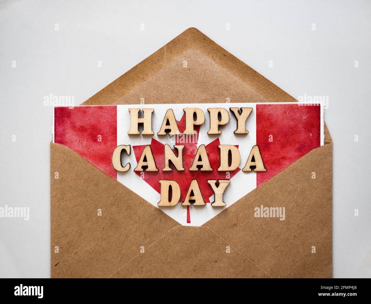 Happy Canadian Day. Postal envelope painted in the national colors of ...