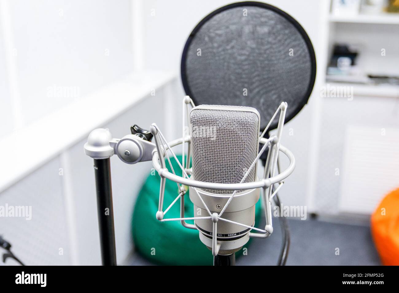 Professional microphone on the background of the light wall. Studio ...
