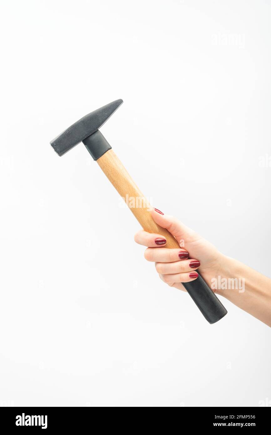 Female hand with red manicure holds hammer. On white background Stock ...