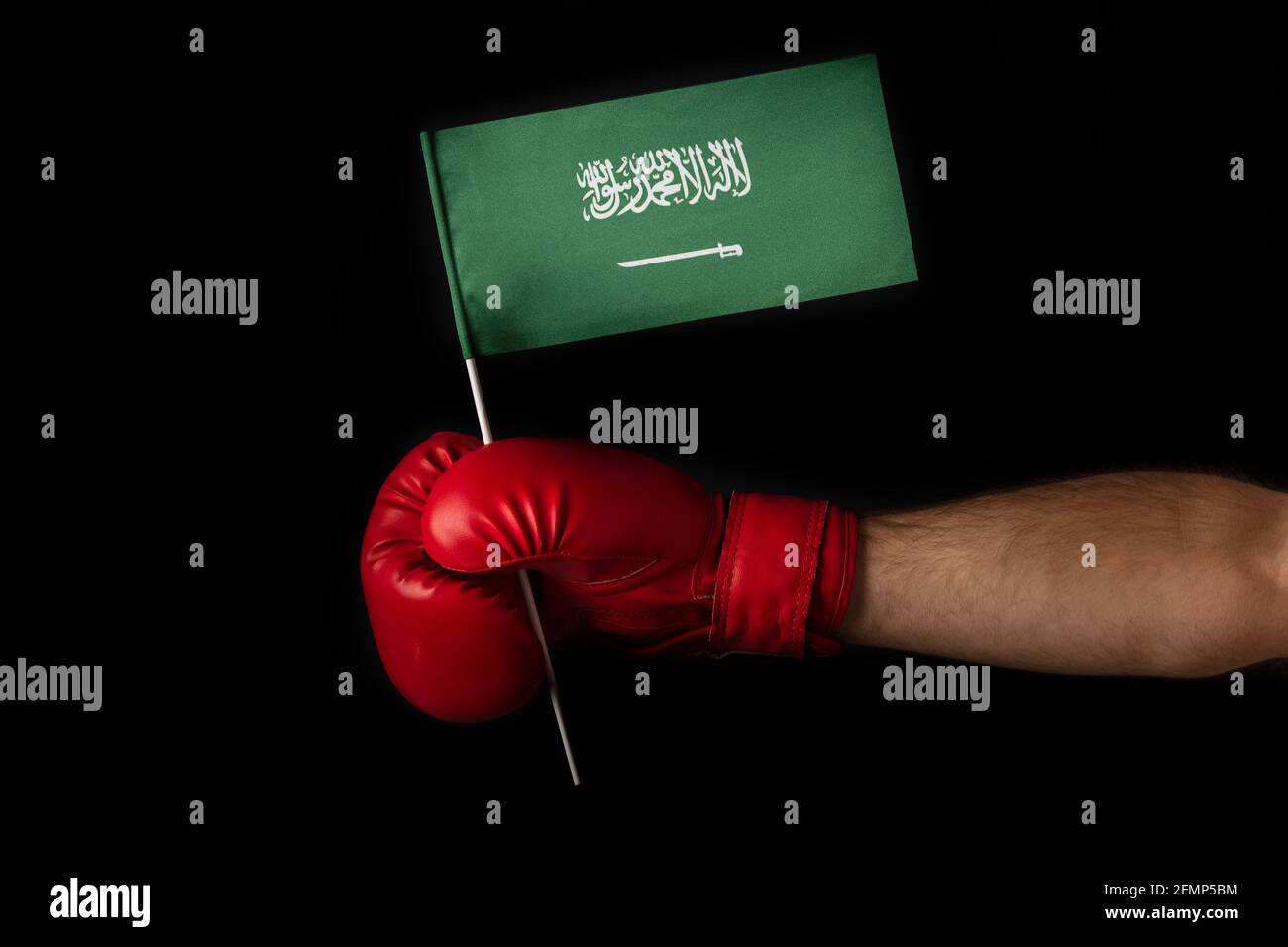 Boxer hand holds flag of Saudi Arabia. Boxing glove with the Saudi ...