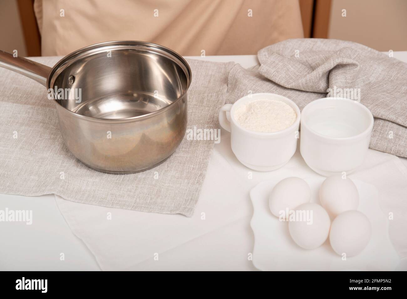 Dough preparation process. Kitchen utensils and products on the table ...