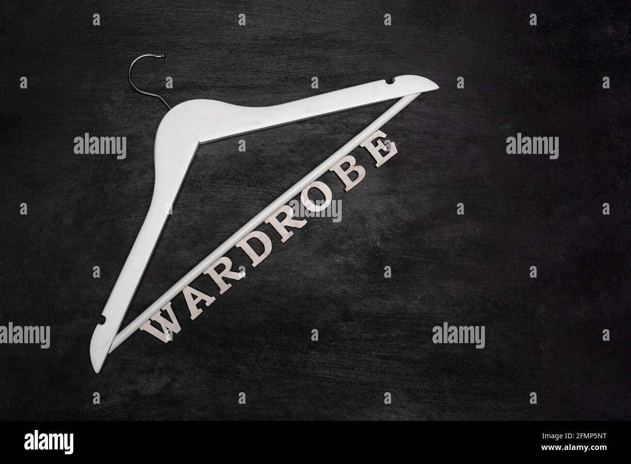 White hangers and word from letters Wardrobe on black background. New ...