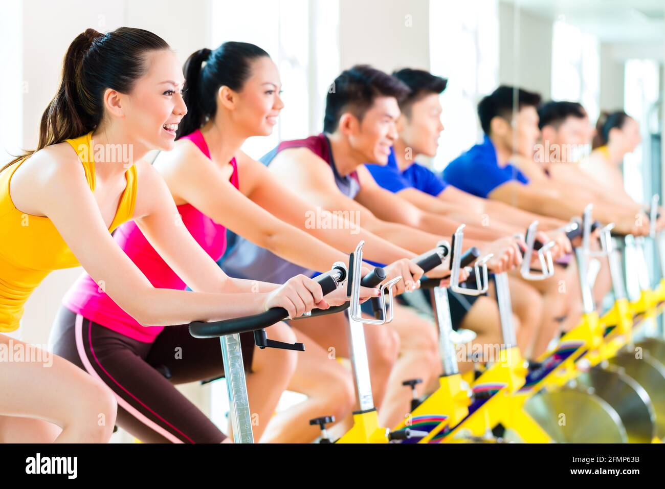 Chinese Asian sport group of men and women in fitness club or gym ...