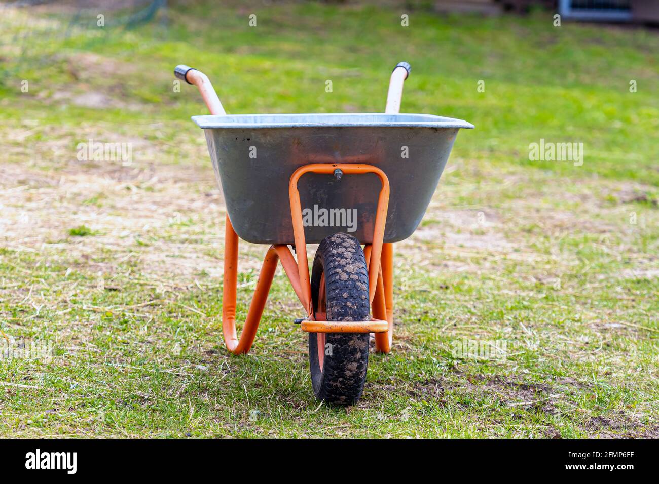 Empty Wheelbarrow In A Garden High Resolution Stock Photography and ...