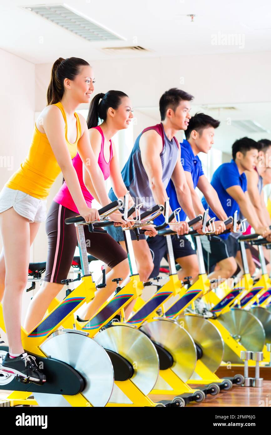 Chinese Asian sport group of men and women in fitness club or gym ...