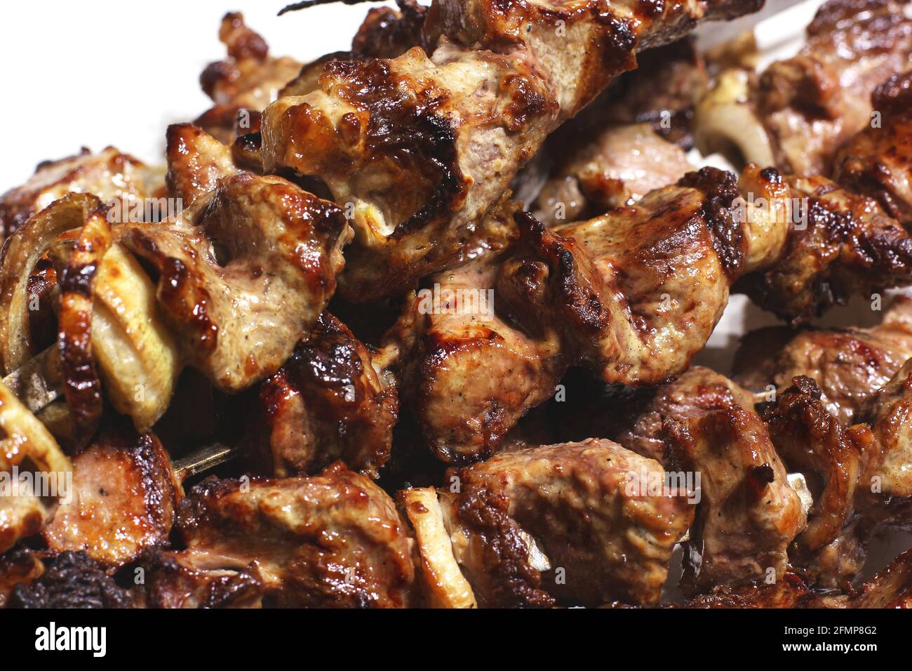 Grilled kebab. Roasted meat with onions. Background from food. Pork ...