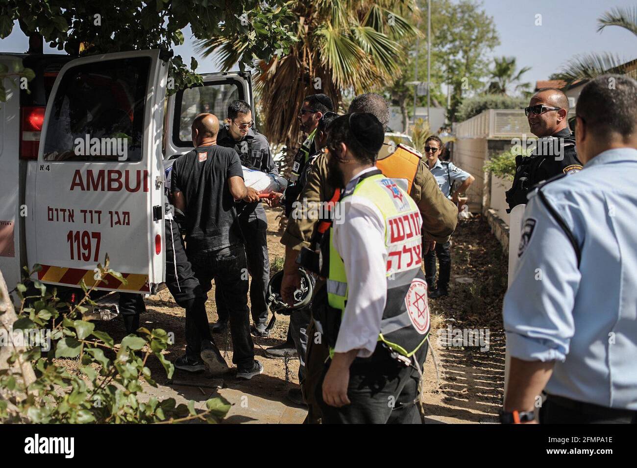 Ashkelon, Israel. 11th May, 2021. Israeli paramedics transport an ...