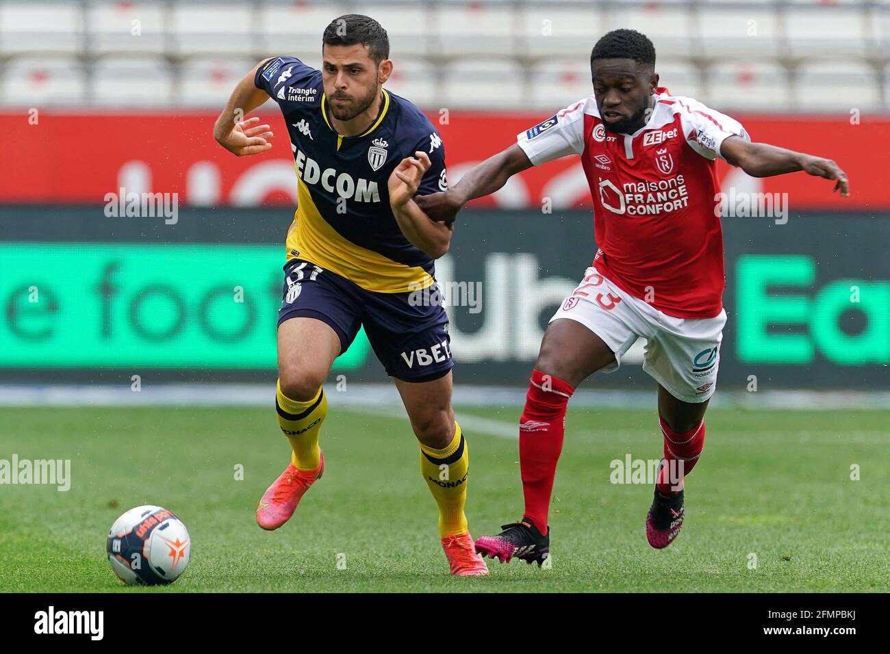 Reims, France. May 9, 2021 Kevin Volland of AS Monaco is challenged by ...