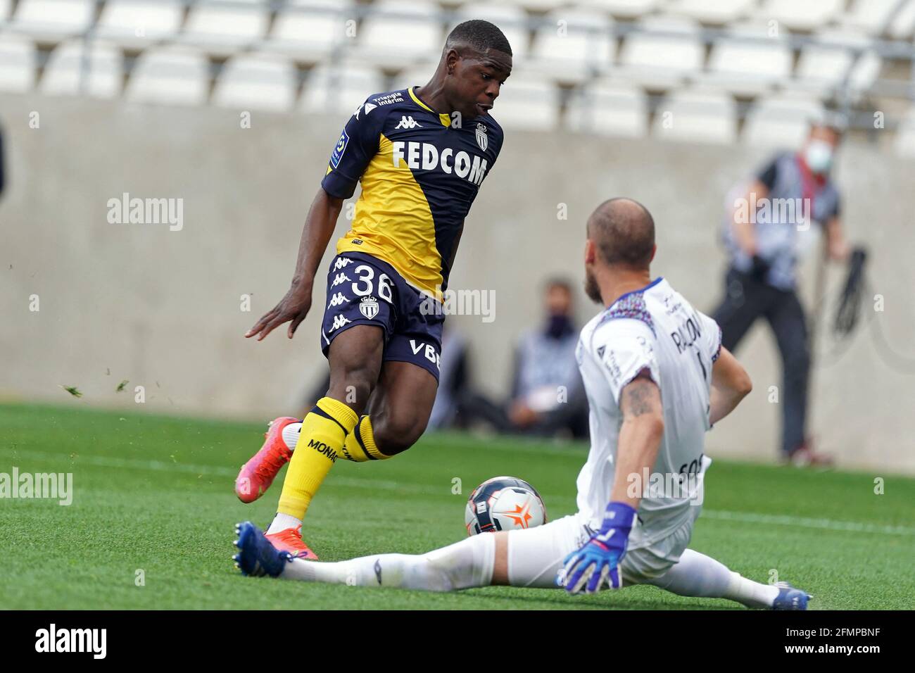 Reims, France. May 9, 2021 Eliot Matazo of AS Monaco is challenged by ...