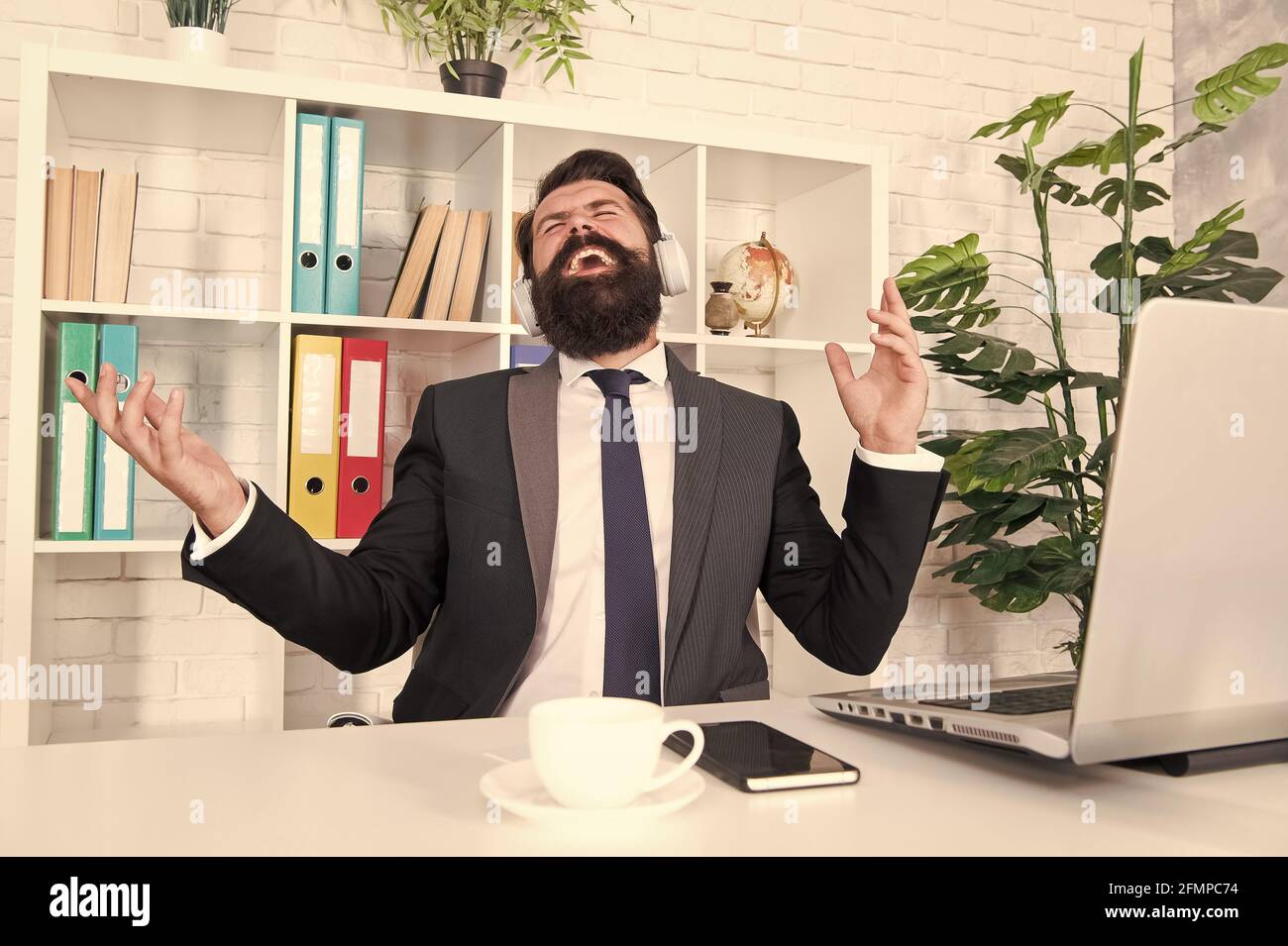 Inspiration concept. Boss at his workplace. Manager with headphones ...