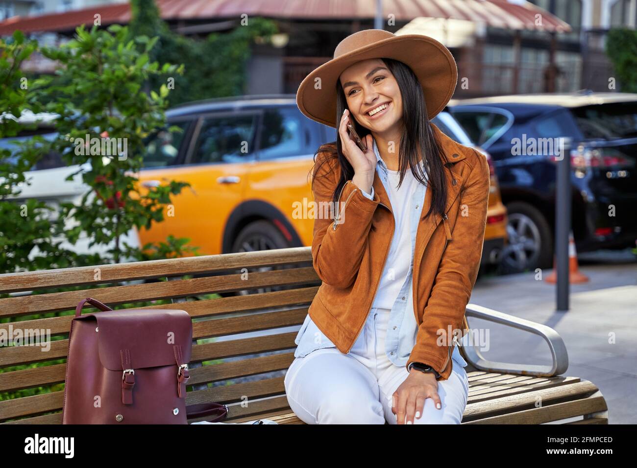 Happy pretty lady enjoying telephone conversation in the city Stock ...