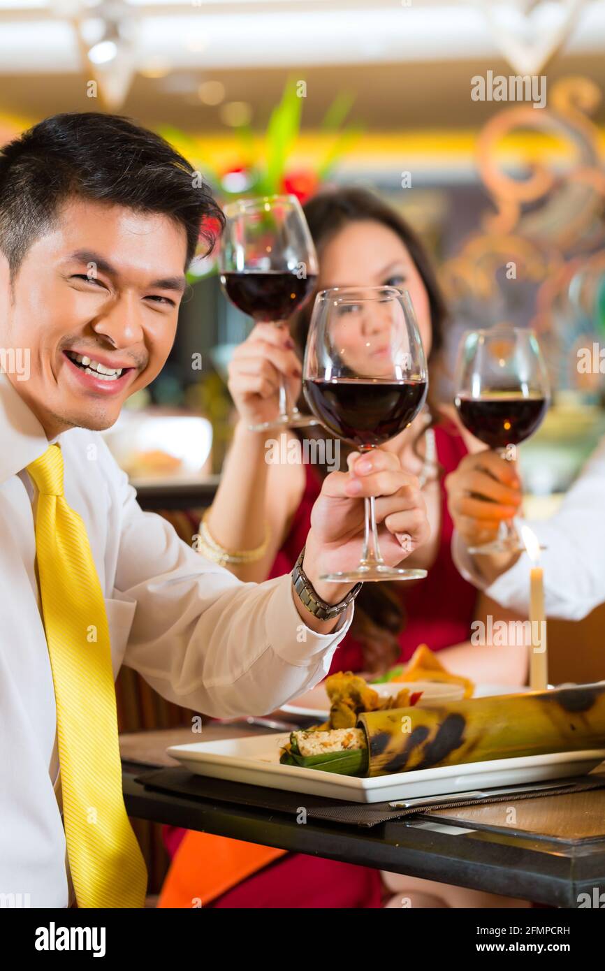 Two Asian Chinese Couples or friends or business people toasting during ...