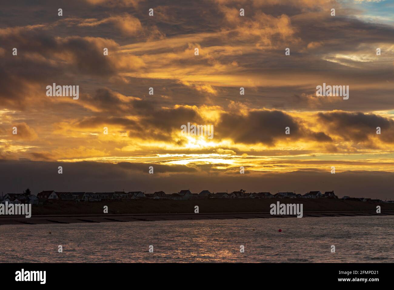 Dramatic sunset over the village of Stud Hill and Seasalter on the Kent ...