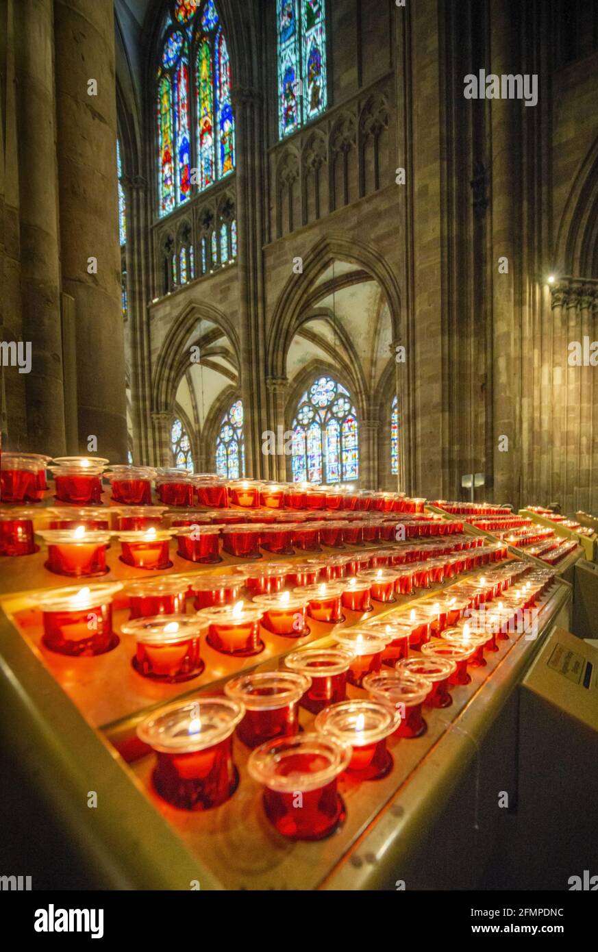 Red glass jars with candles in a beautiful gothic cathedral Stock Photo ...