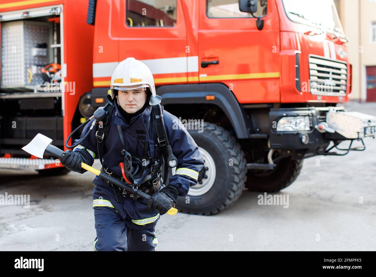 Portrait of serious and confident caucasian fireman standing and ...