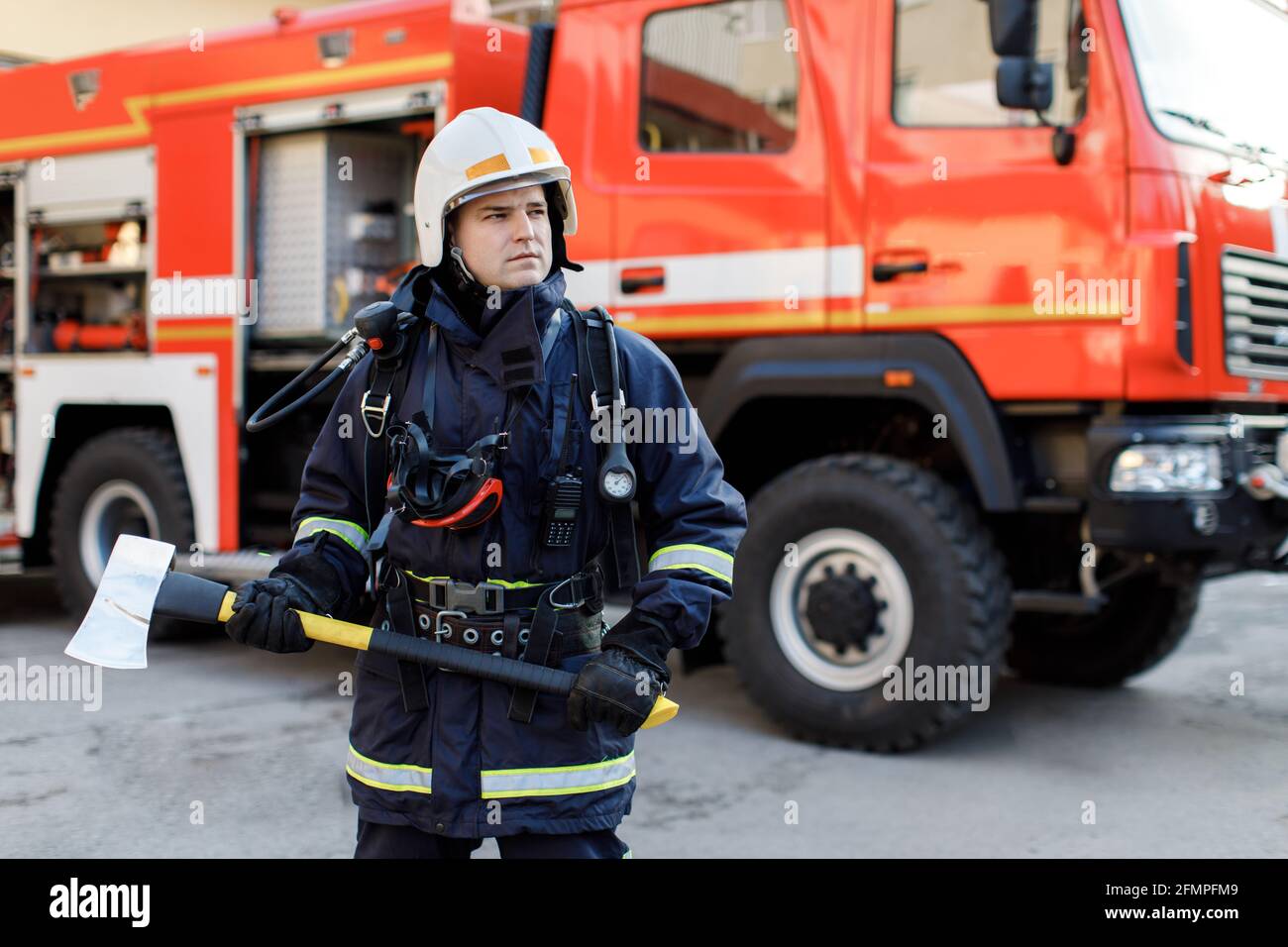 Portrait of serious and confident caucasian fireman standing and ...