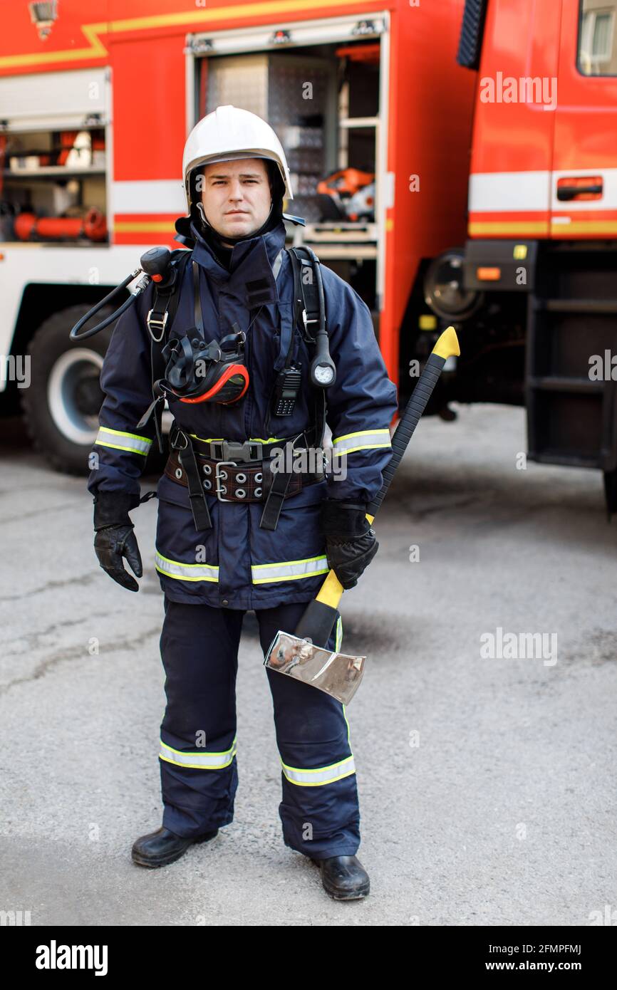 Portrait of serious and confident caucasian fireman standing and ...