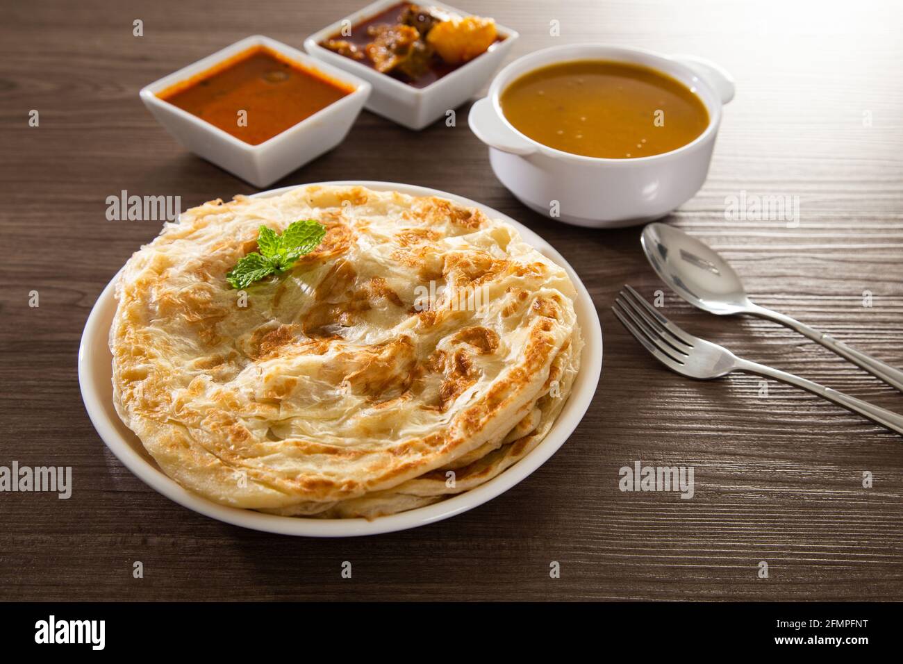 Roti Parata or Roti canai with lamb curry sauce - popular Malaysian ...