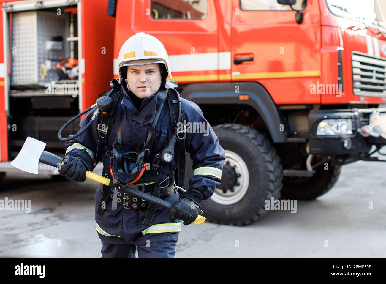 Portrait of serious and confident caucasian fireman standing and ...
