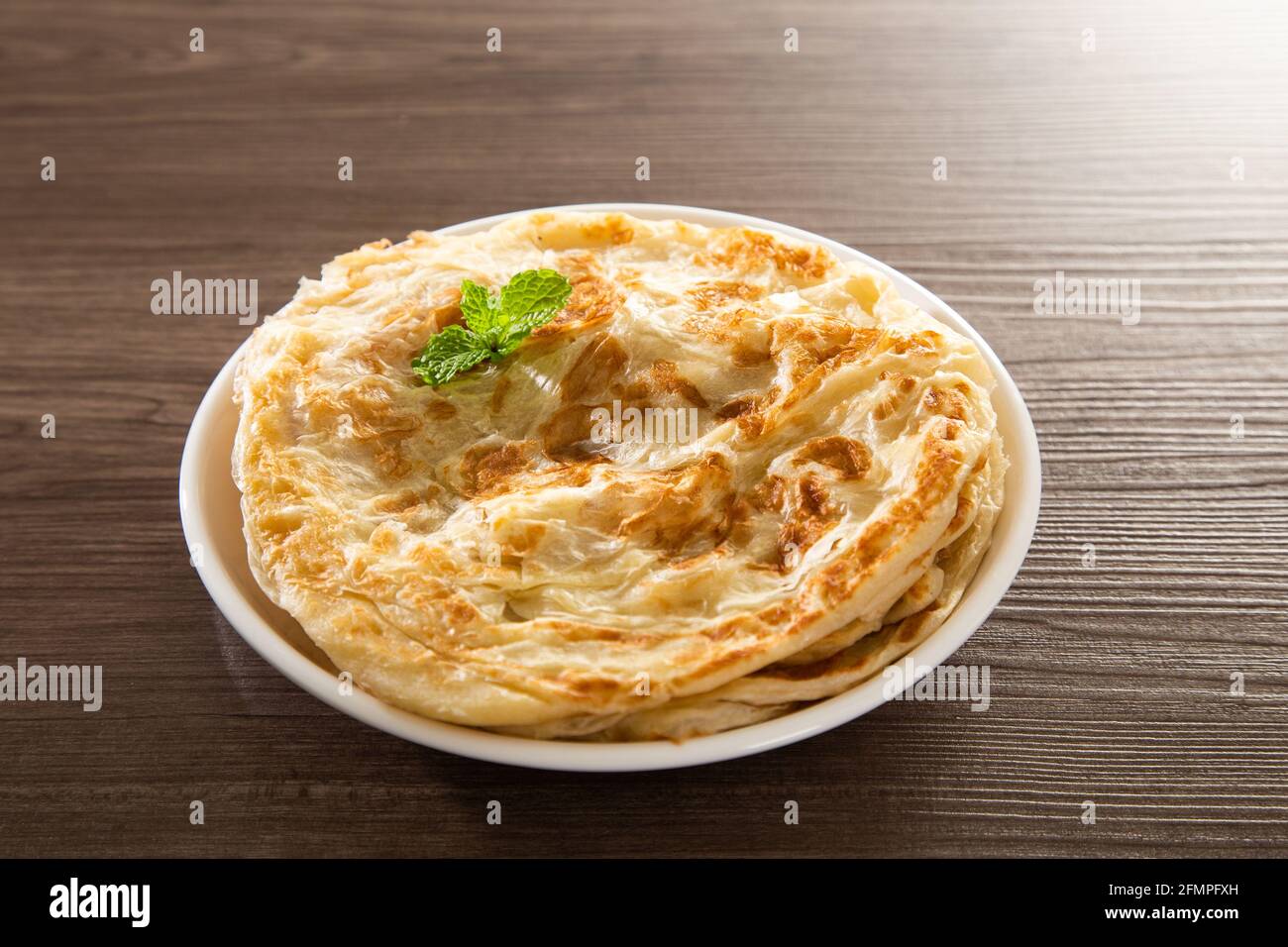 Roti Parata or Roti canai with lamb curry sauce - popular Malaysian ...