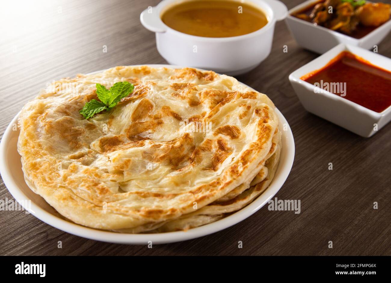 Roti Parata or Roti canai with lamb curry sauce - popular Malaysian ...