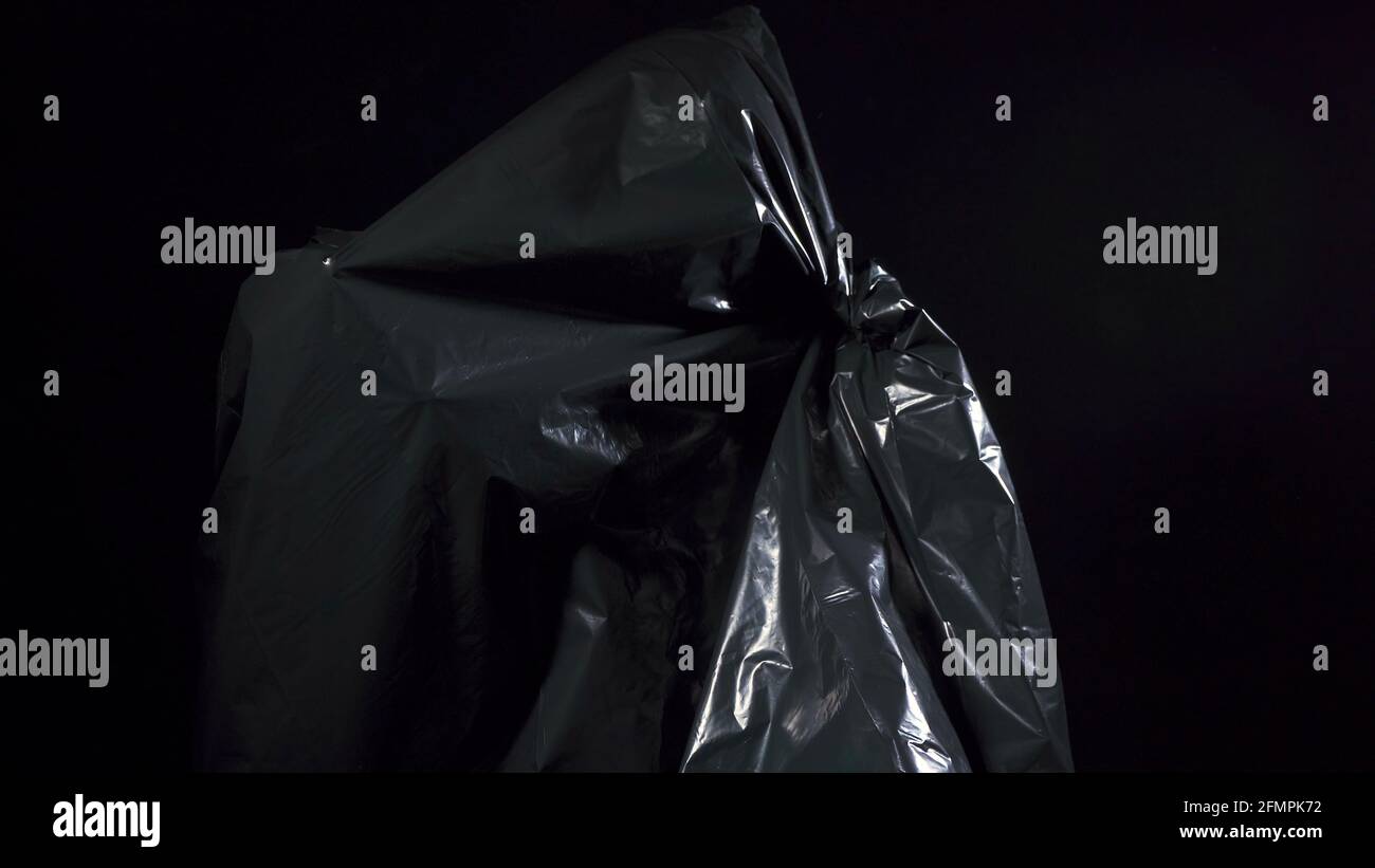 Photo of human in garbage black bag Stock Photo - Alamy