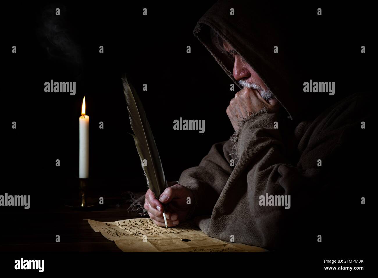 Medieval poor monk writes letter Stock Photo - Alamy