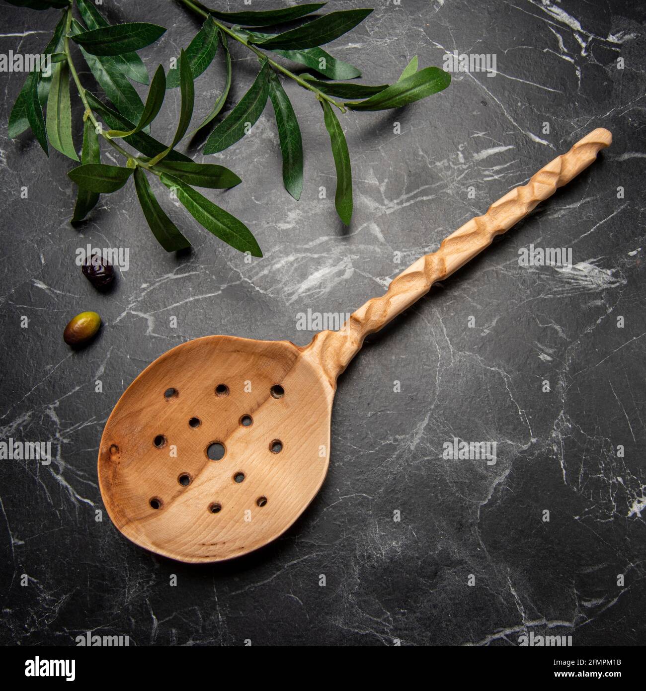 hand carved kitchen spoon in the kitchen Stock Photo - Alamy