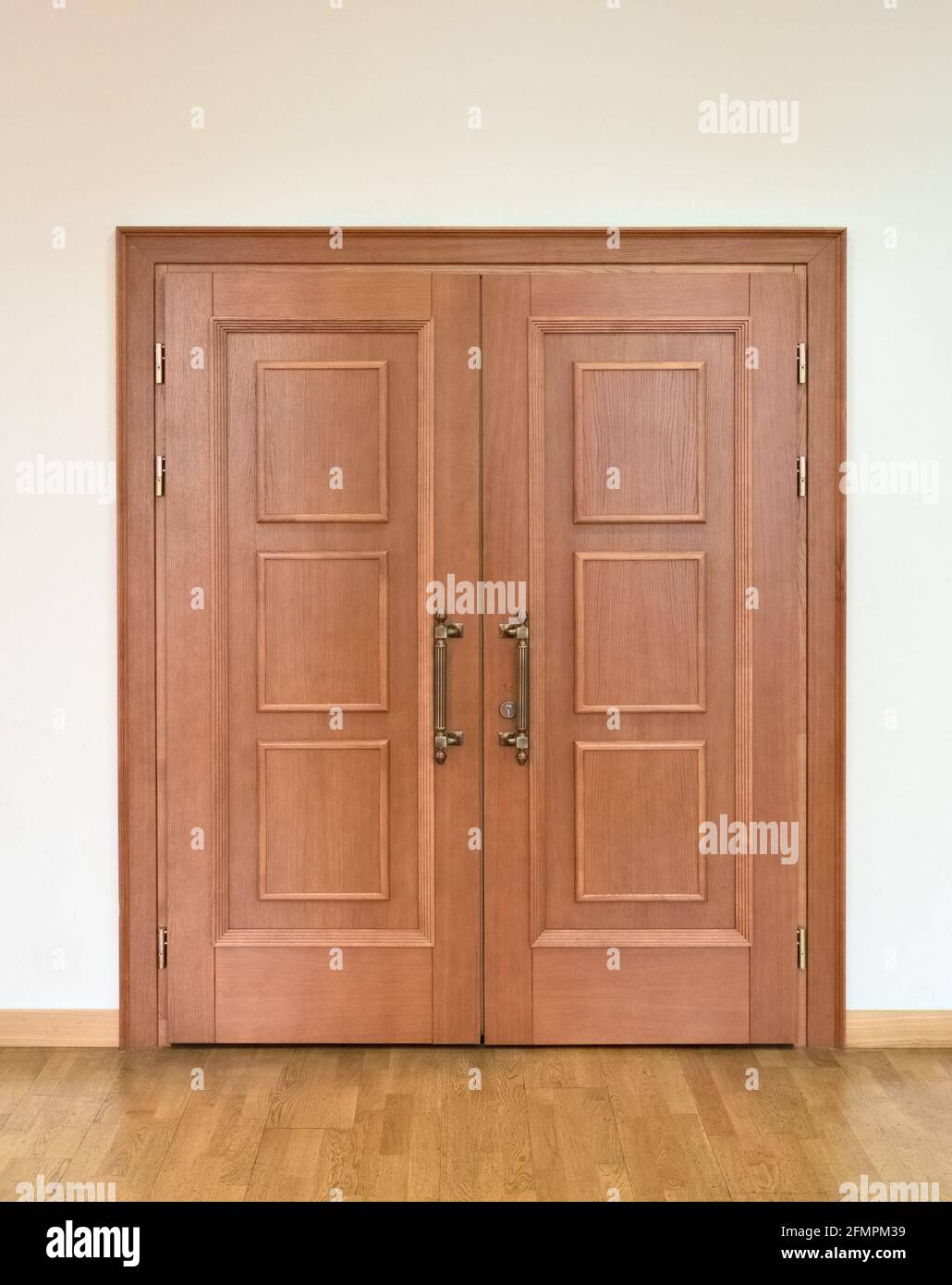 Wooden doors with bronze handles in a concourse Stock Photo - Alamy