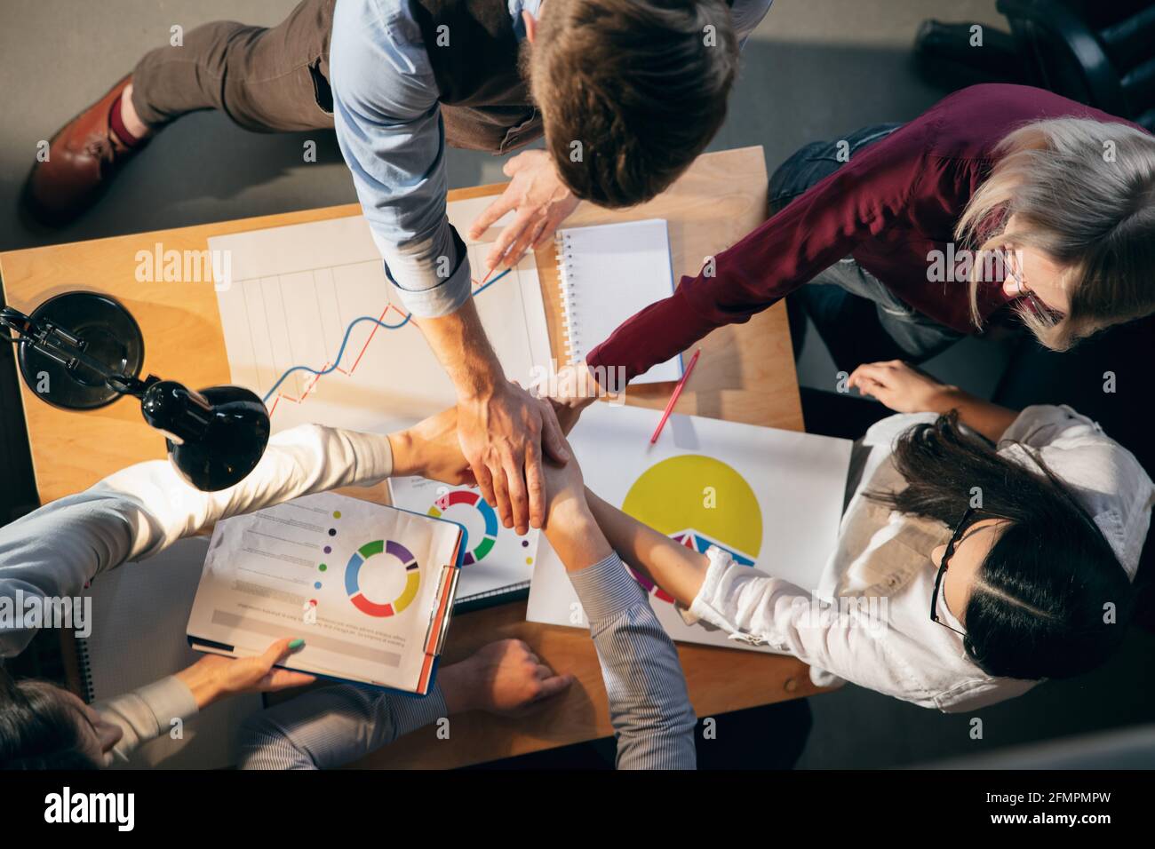 Colleagues working together in modern office using devices and gadgets ...