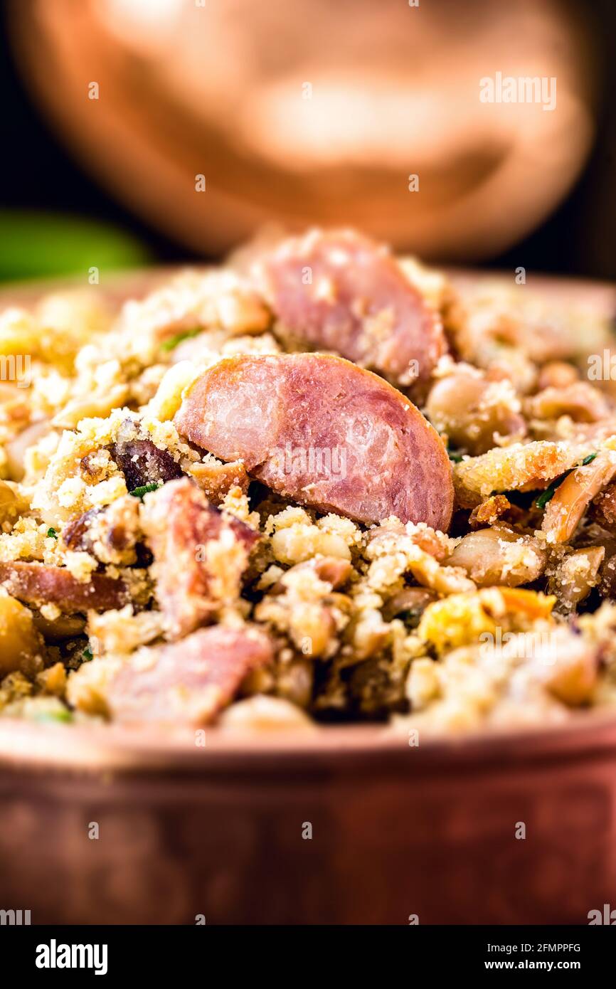 Brazilian culinary dish, beans with pork, pepperoni, farofa and ...