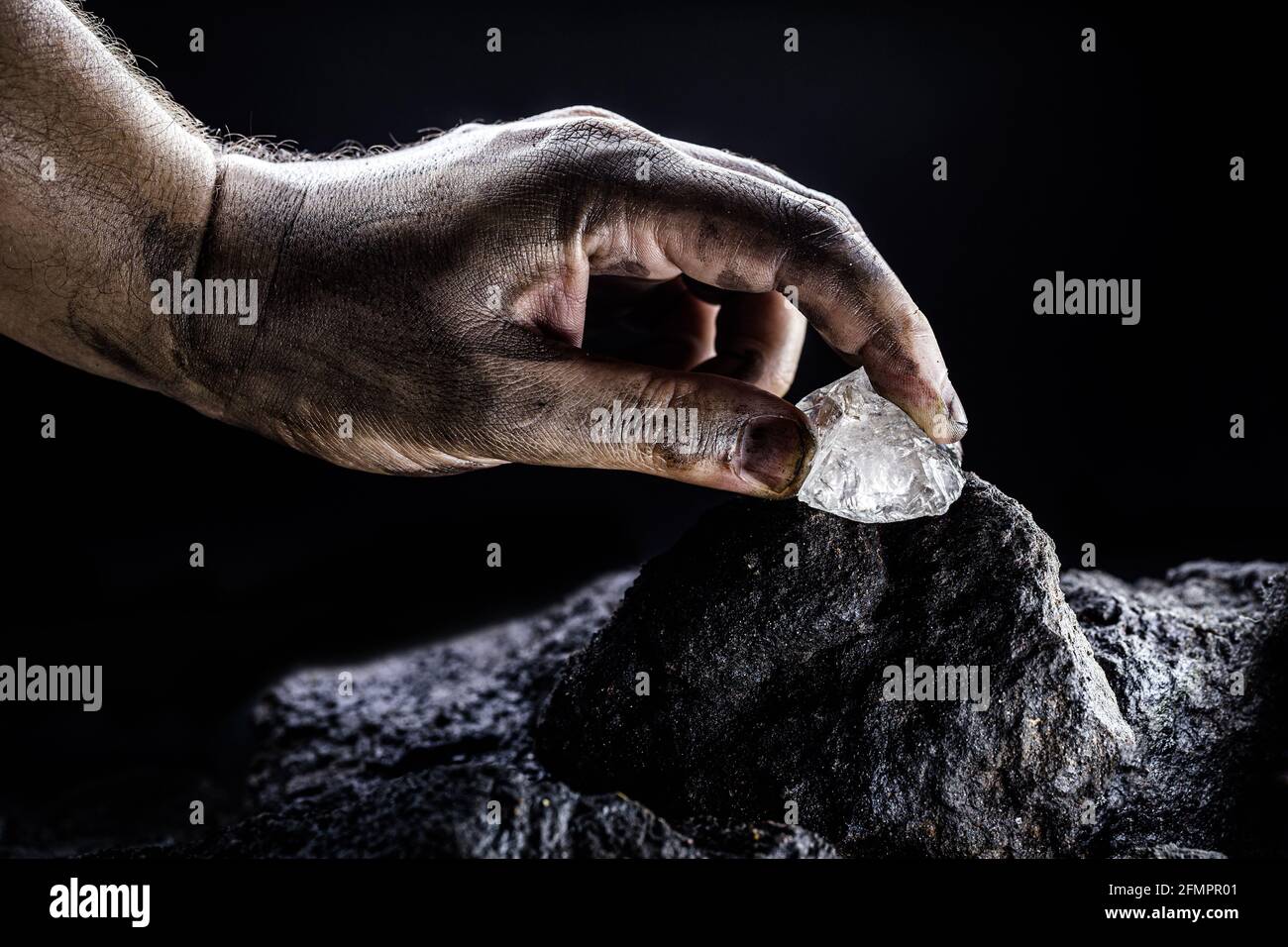 rough diamond being removed by miner hand, mining concept Stock Photo ...