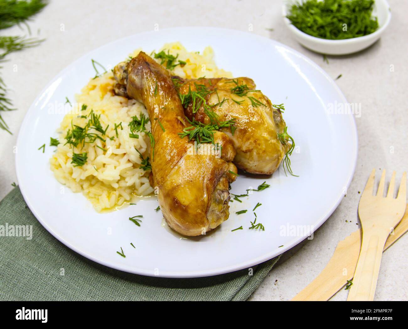 Roasted chicken drumsticks white rice with green herbs. Traditional ...