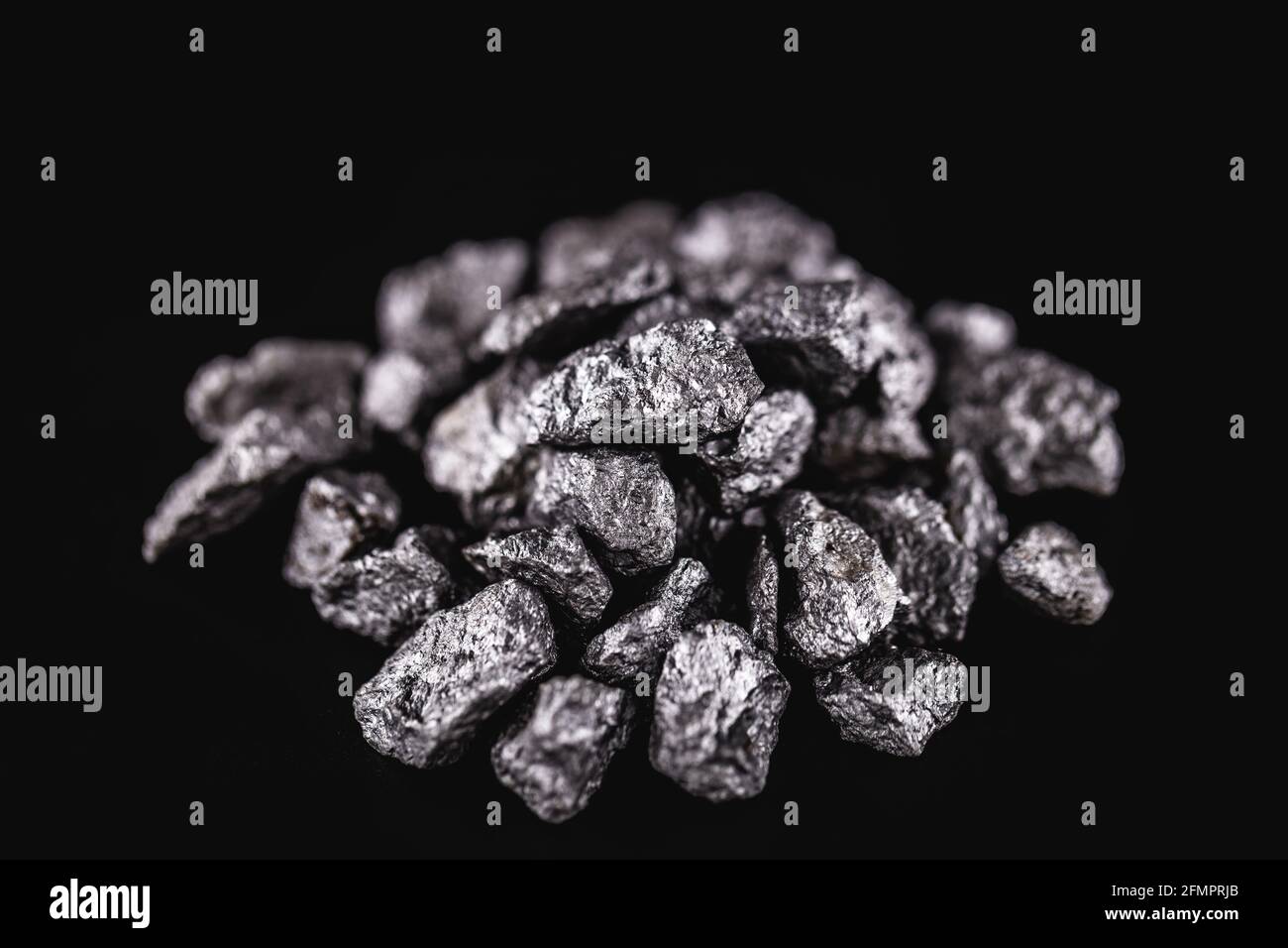 various rough silver nuggets on black background, texture of silvery ...