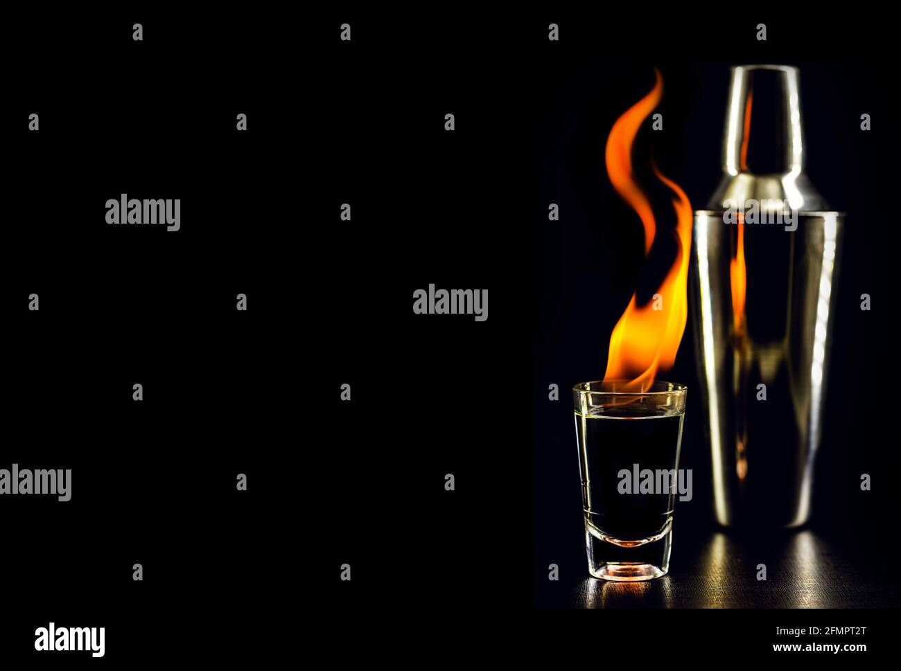 Burning alcoholic drinks with big flame, on black background with copy ...