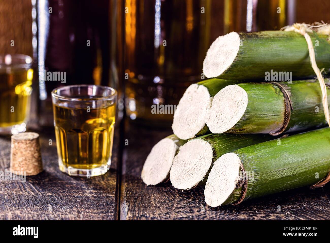 sugar cane used in distilled drinks, barrel bottom and glass with ...