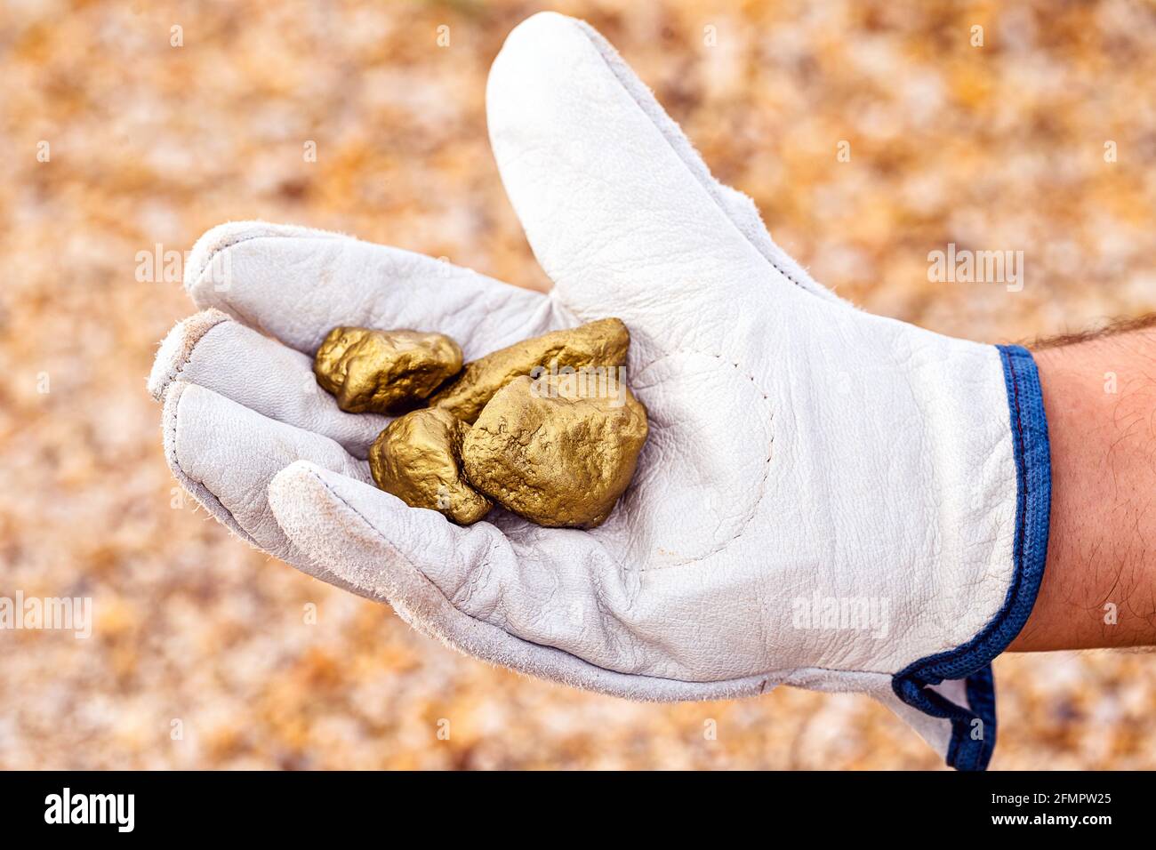 miner hand holding stones from another, gold mineral extraction ...
