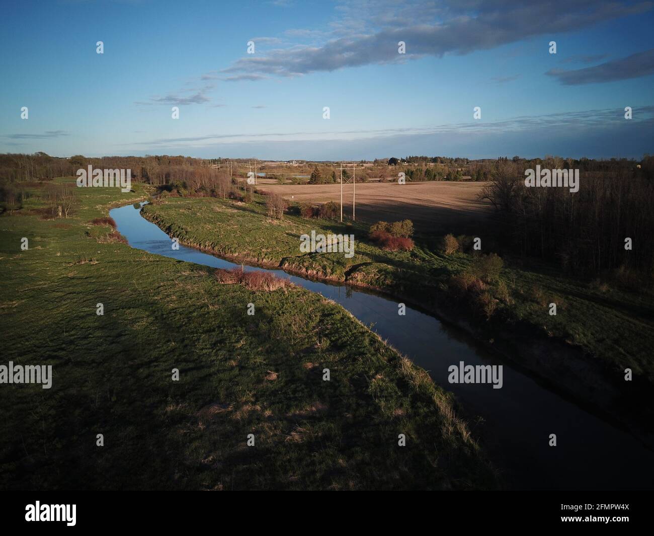 Aerial view of colorful pond in the marshlands during a fall season day ...