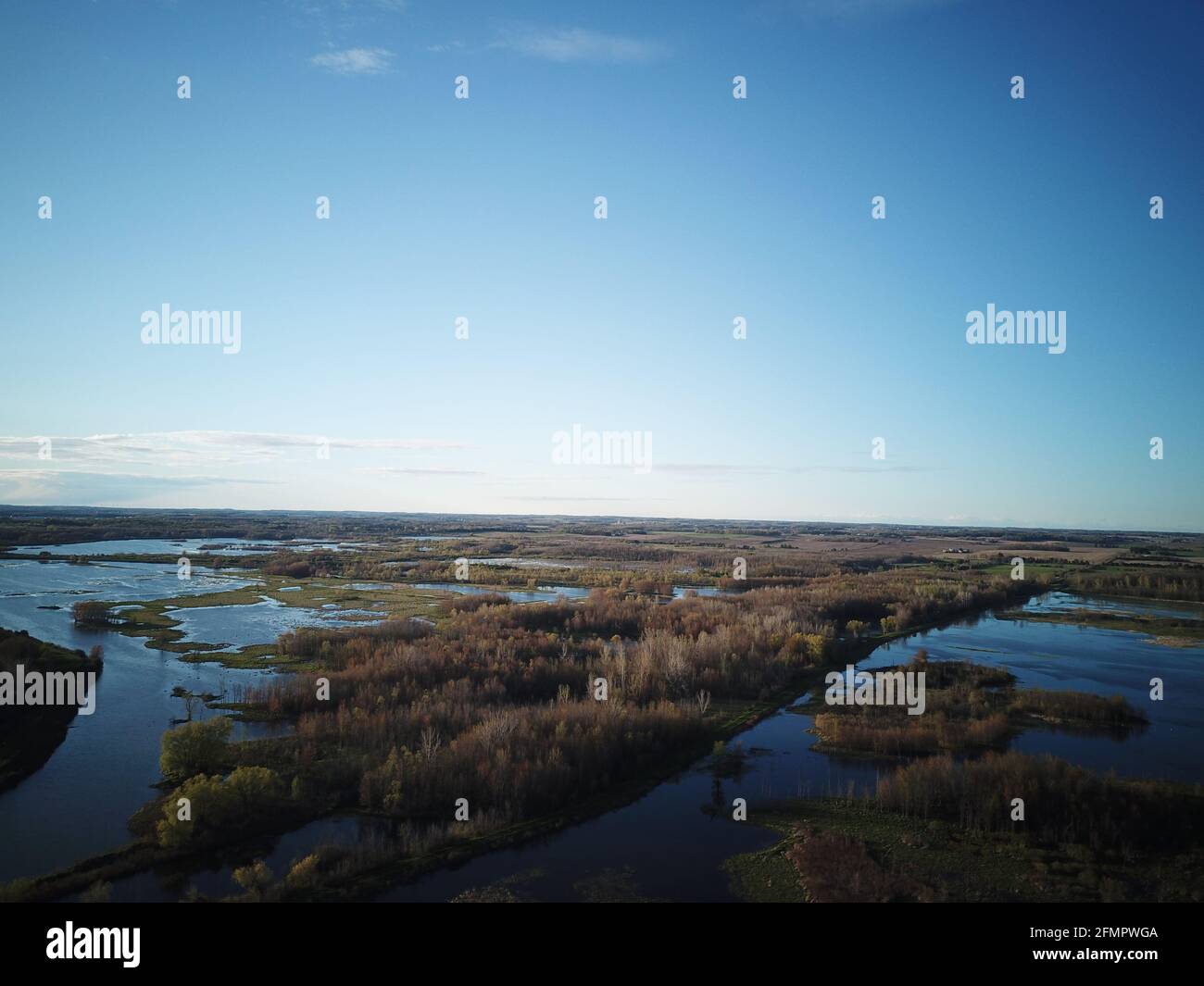 Aerial view of colorful pond in the marshlands during a fall season day ...