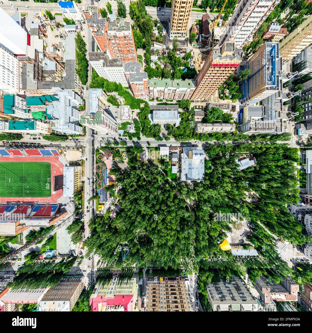 Aerial city view with crossroads and roads, houses, buildings, parks ...