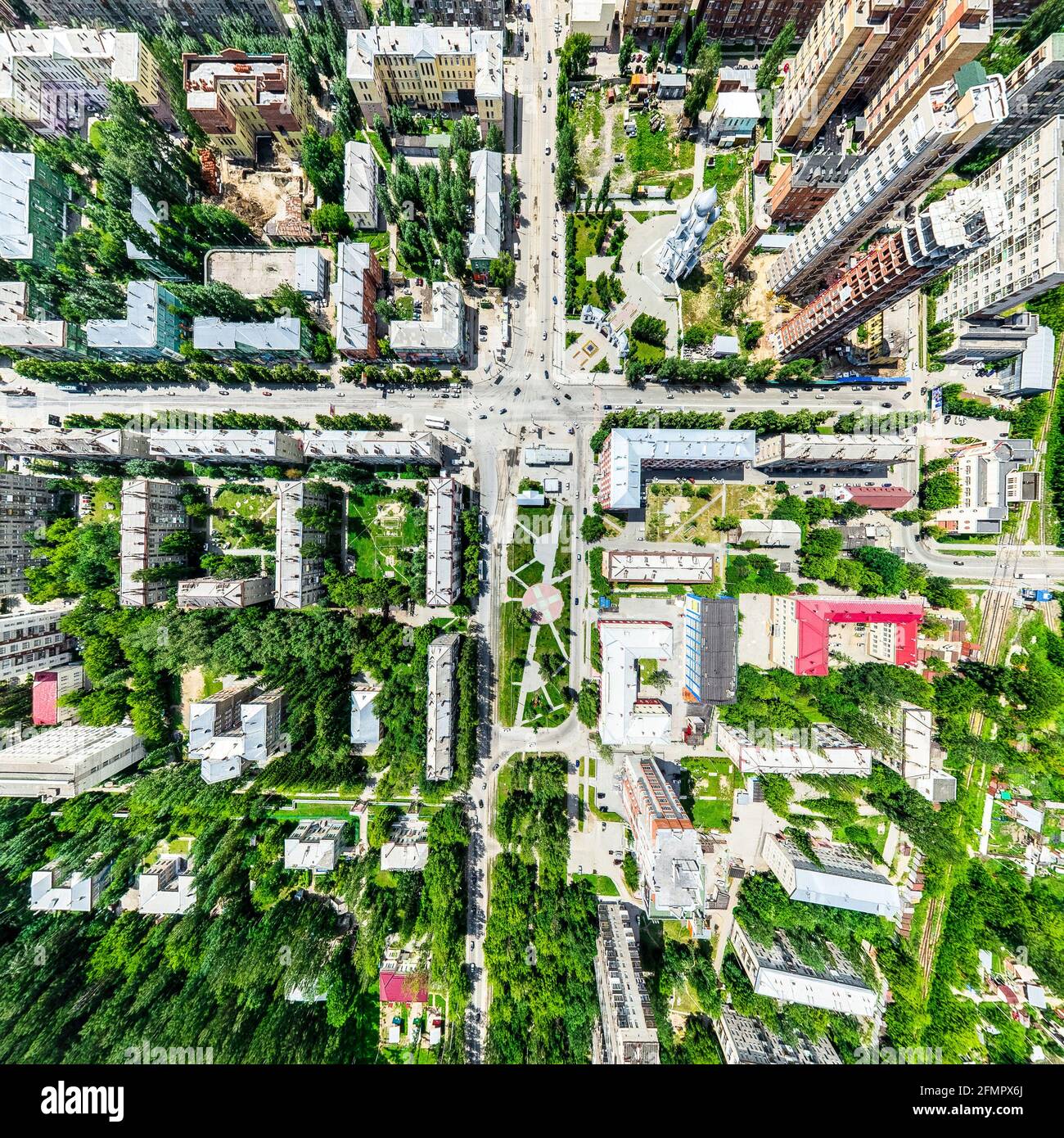 Aerial city view with crossroads and roads, houses, buildings, parks ...