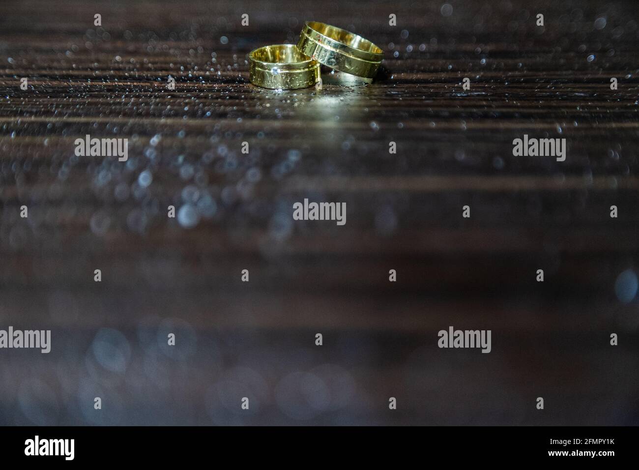 Wedding rings on a wooden surface with copy space Stock Photo - Alamy