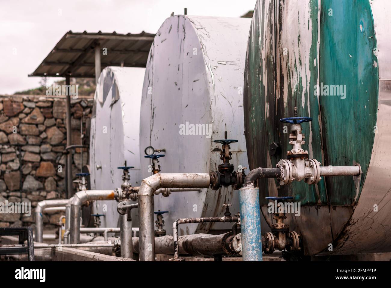 Row of fuel containers in a factory Stock Photo - Alamy