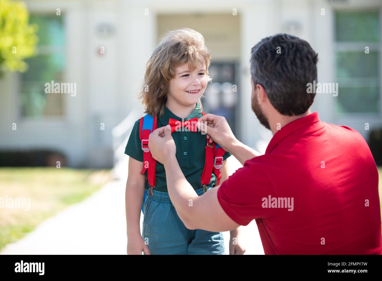 Father saying goodbye to his little child son near school. Kids ...