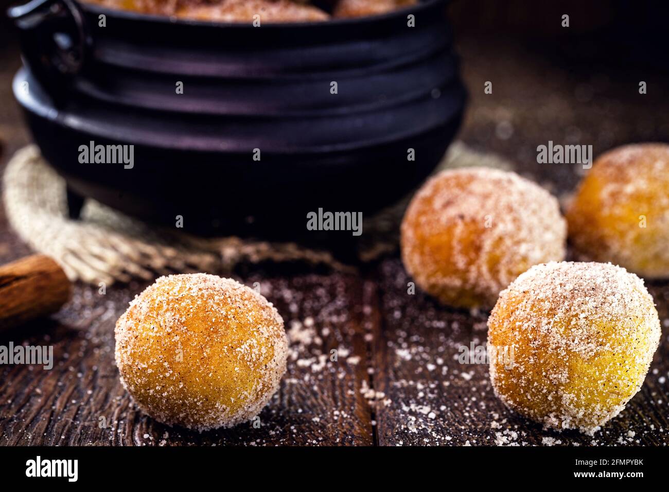 aditional Brazilian mini fried cake called "Fritter" with rustic wooden ...