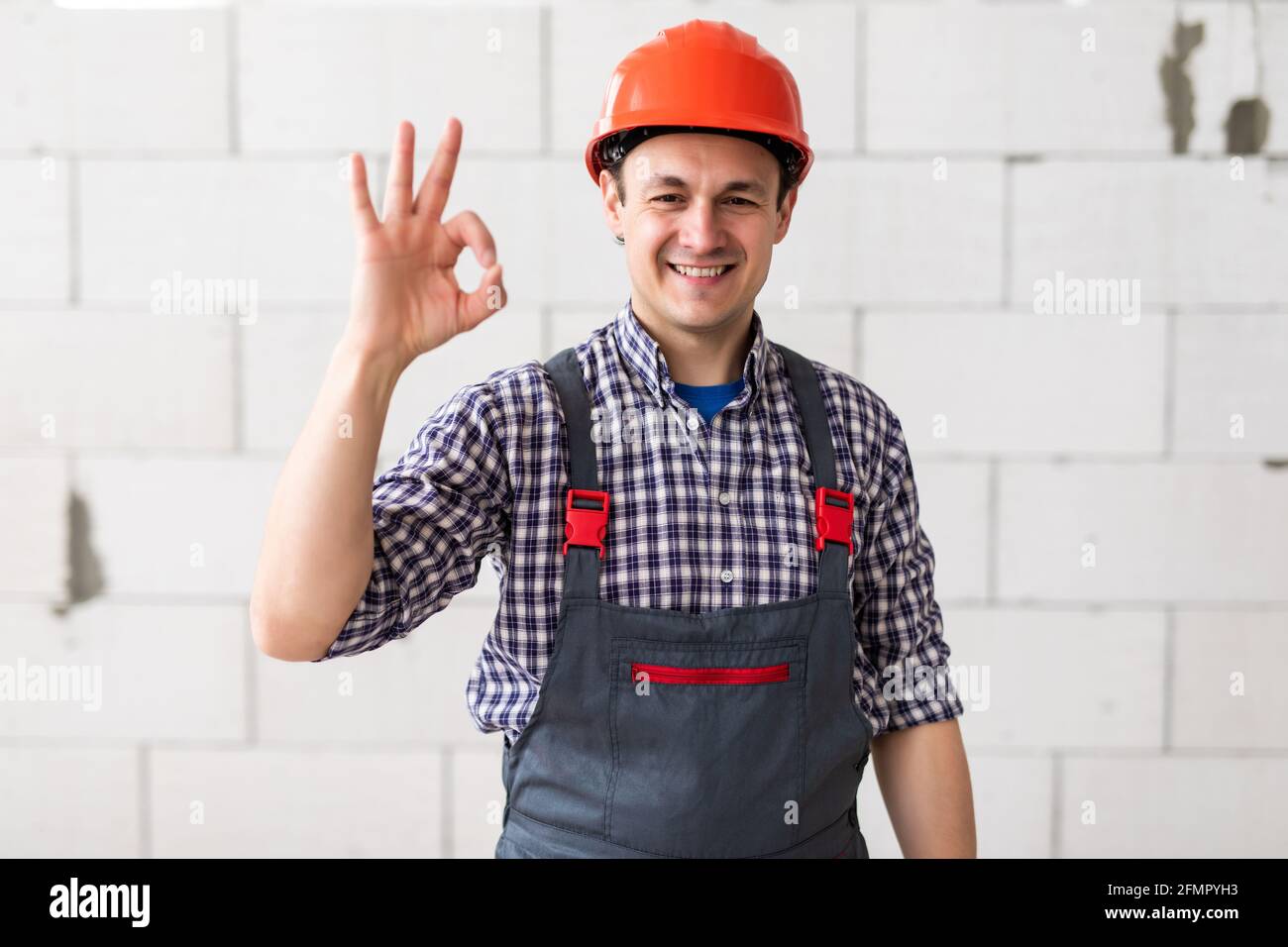 Happy constructor doing ok sign gesture as great building services ...