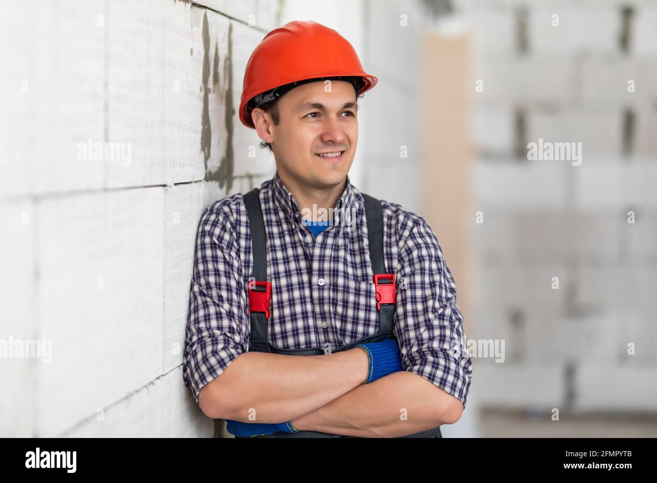 Construction worker with safety helmet on head in vest standing with ...