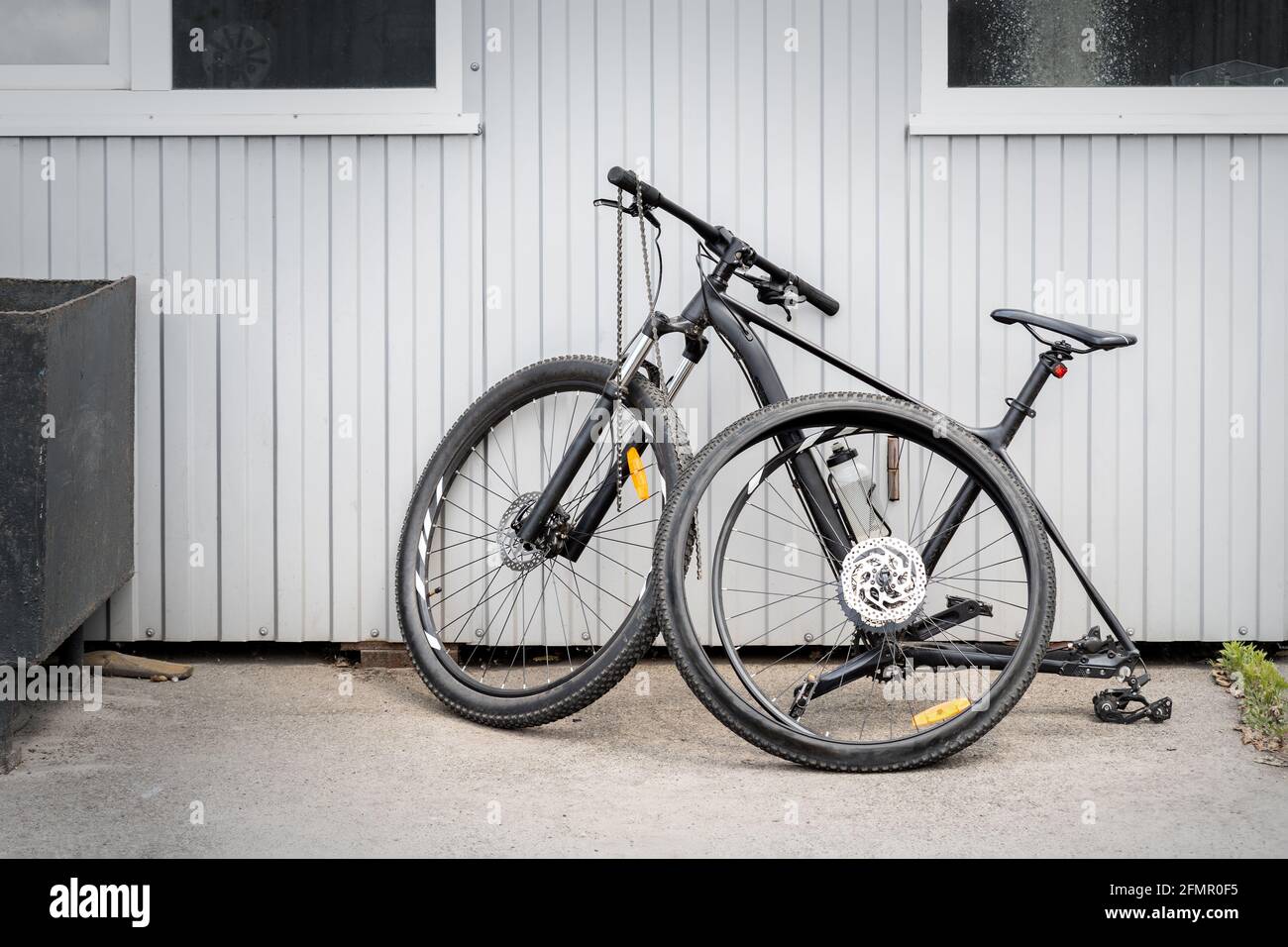 Disassembled black carbon fiber bicycle with removed wheel and tyre ...